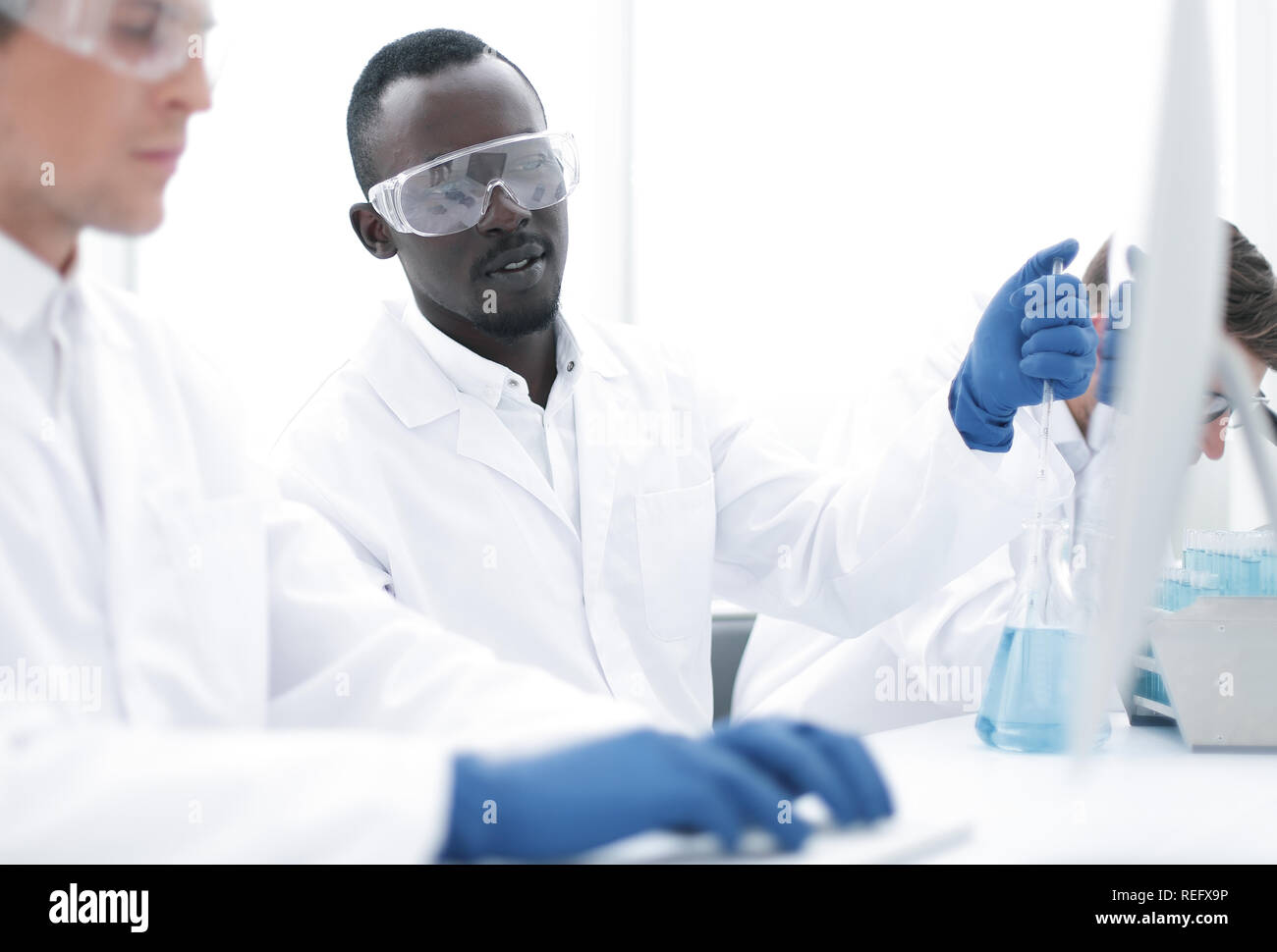 group of scientists using a computer to enter data Stock Photo - Alamy