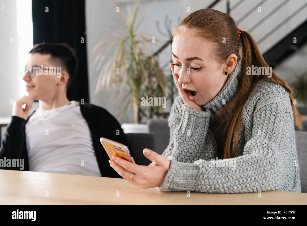 SMS. Closeup portrait funny shocked anxious scared young girl looking ...