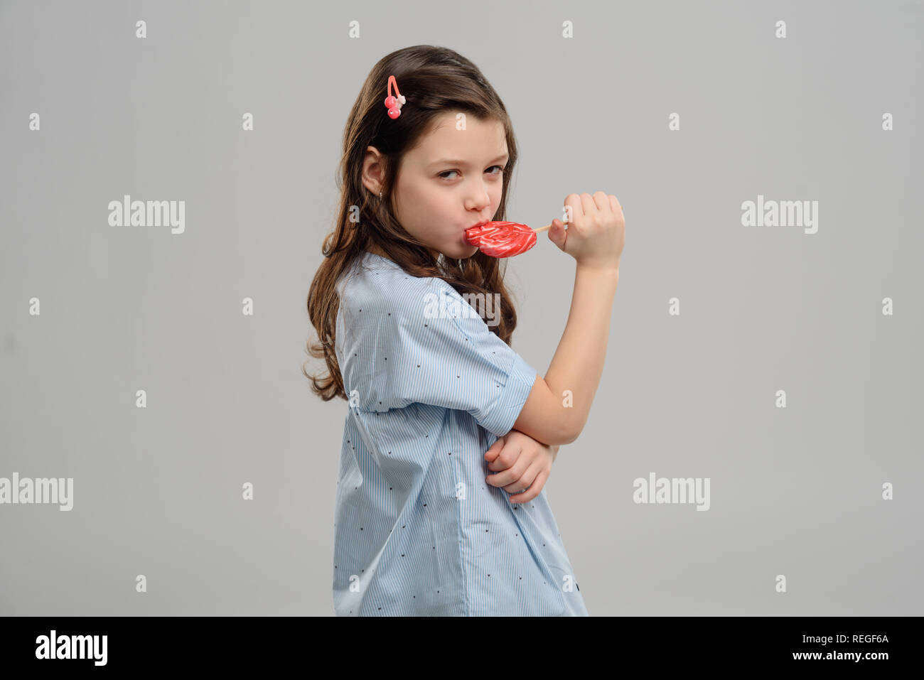 Girl eating a hard candy Stock Photo - Alamy