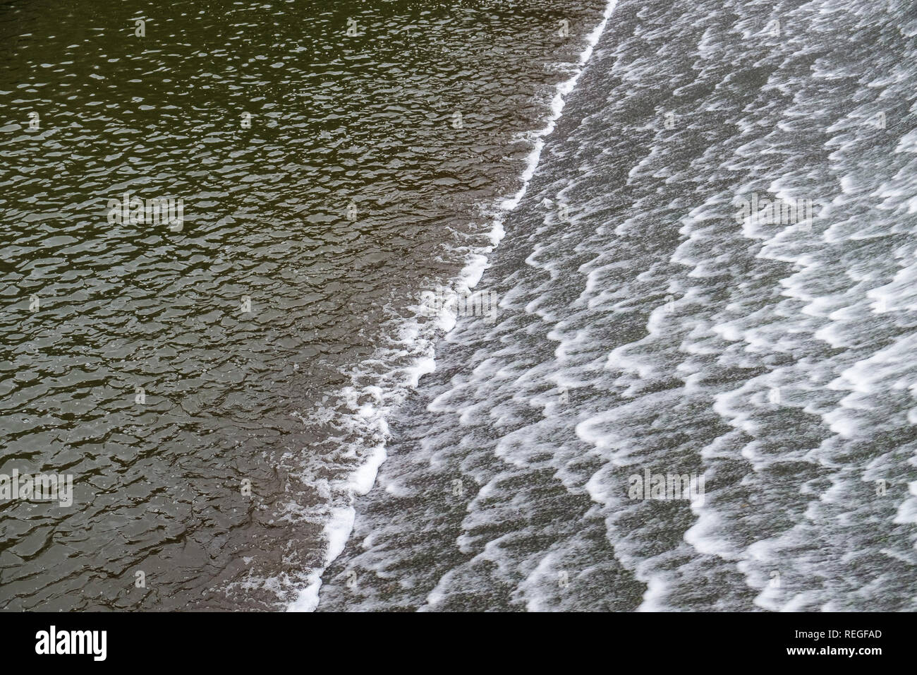 Water flowing down the spillway at Porth Reservoir in Cornwall Stock ...