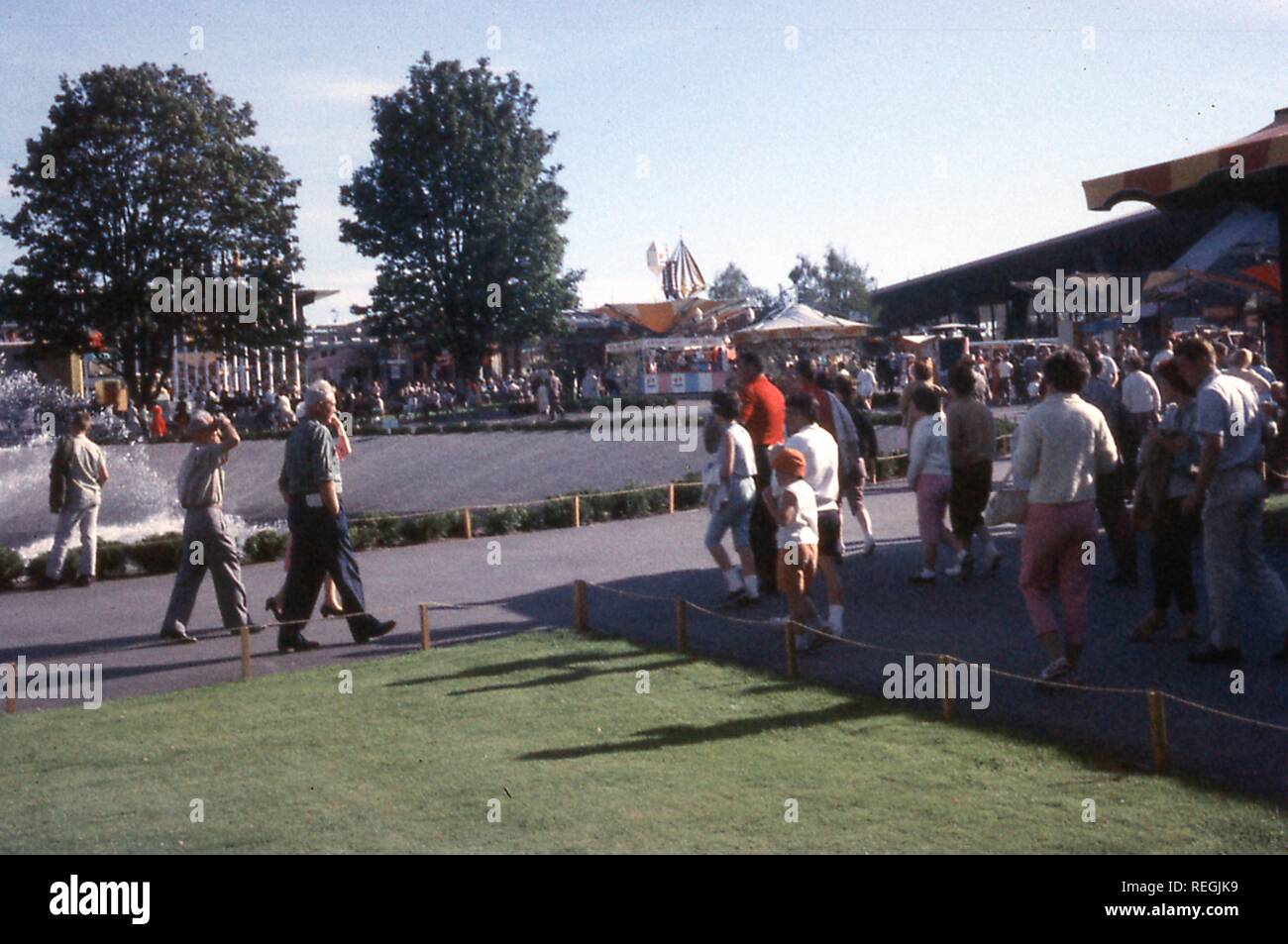 View of visitors walking next to the edge of the International Fountain ...