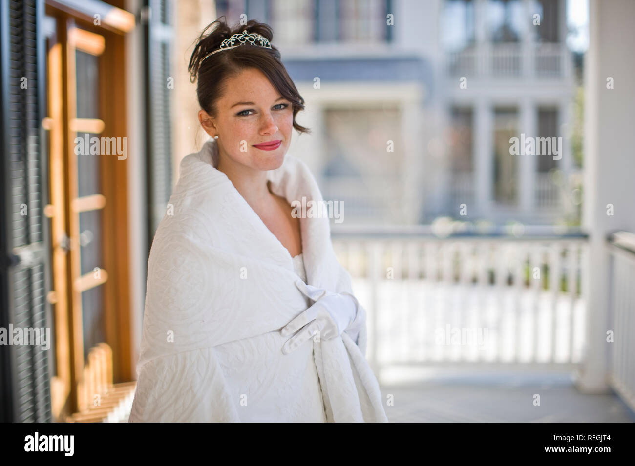 Bride standing on deck wrapped in white shawl Stock Photo - Alamy