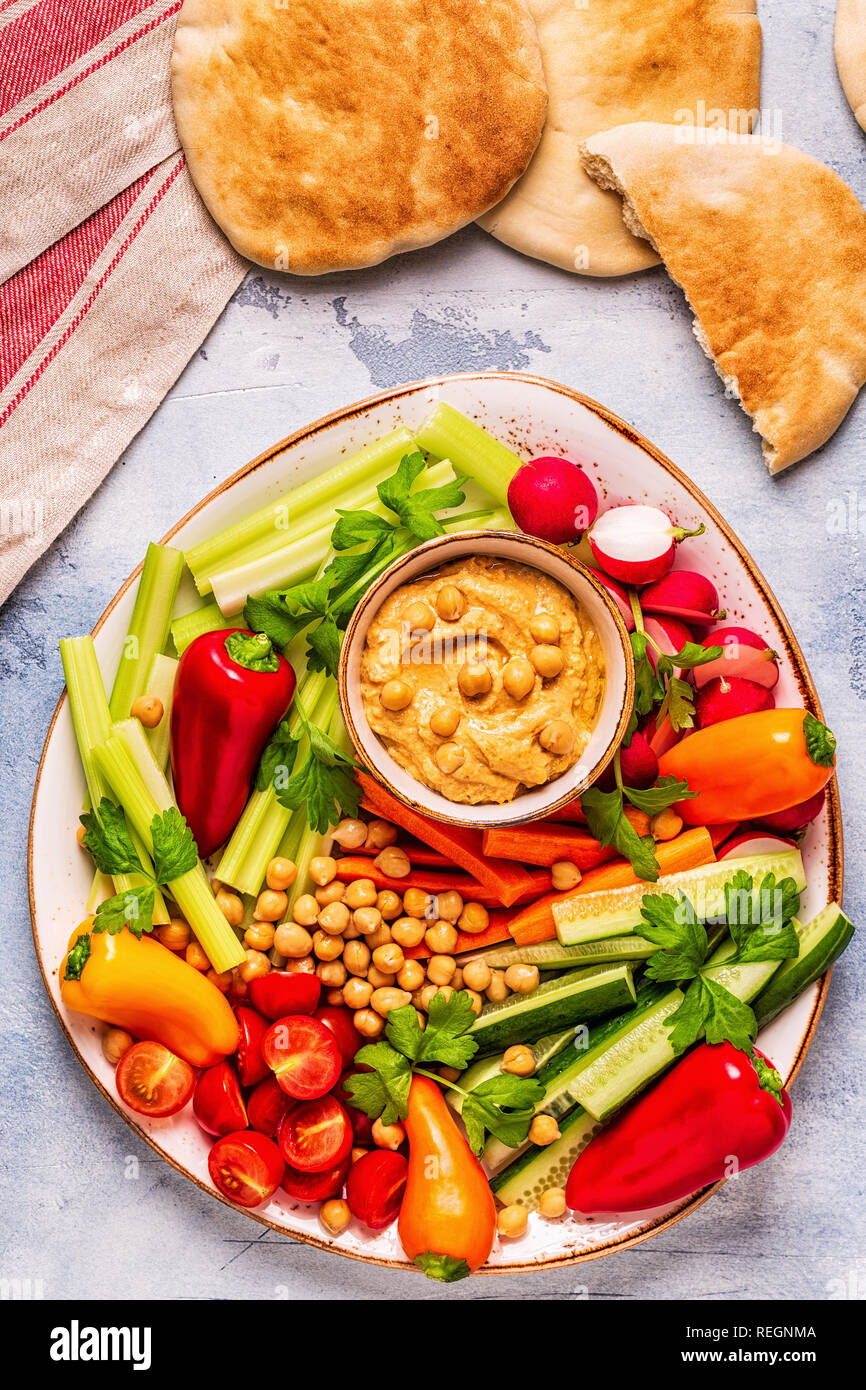 Hummus with various fresh raw vegetables, top view Stock Photo - Alamy