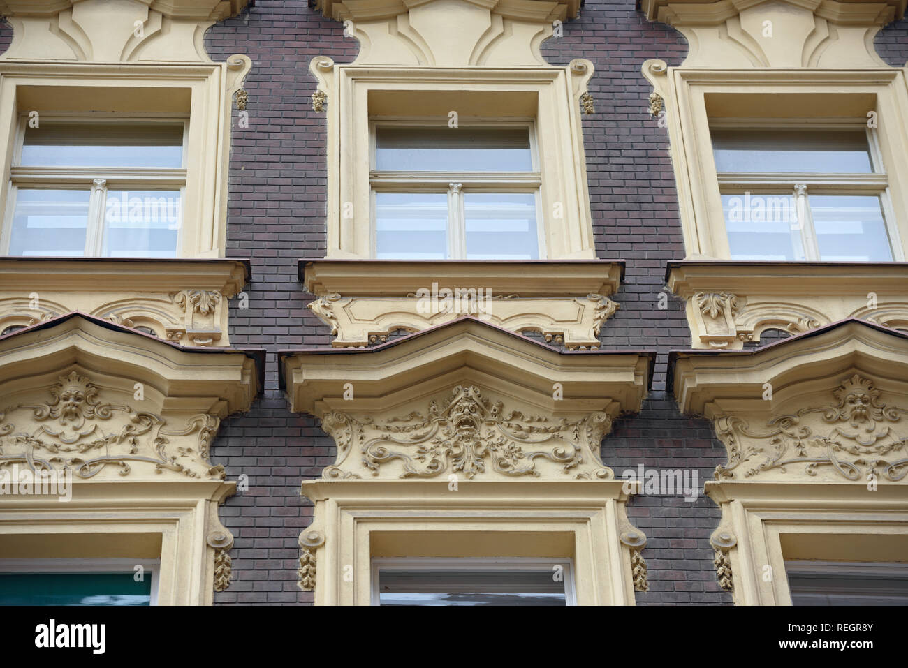 Close-up ornate window frames with sculptured pediment old building on ...
