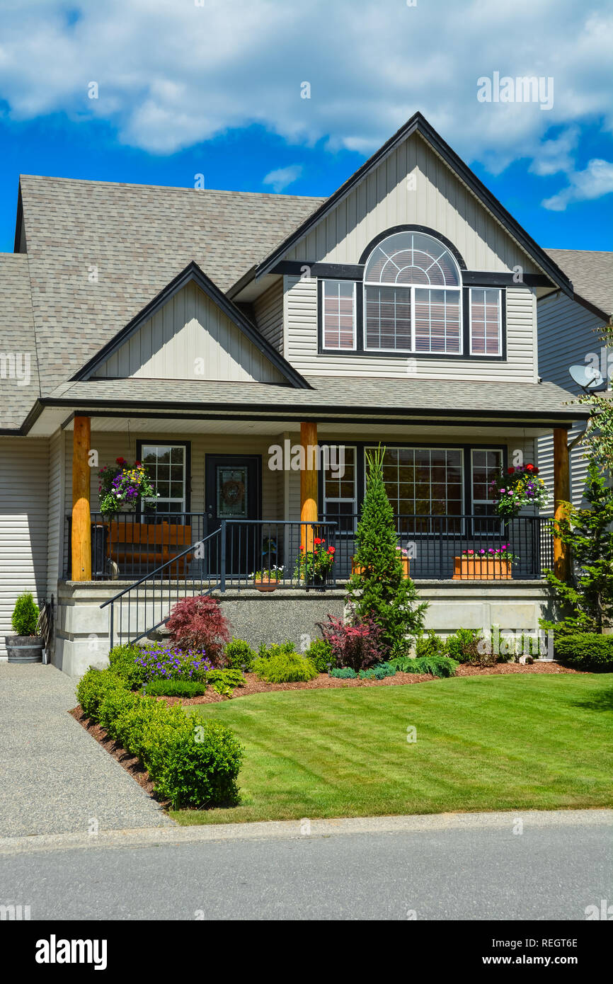 Suburban house with landscaping in front and blue sky background Stock ...