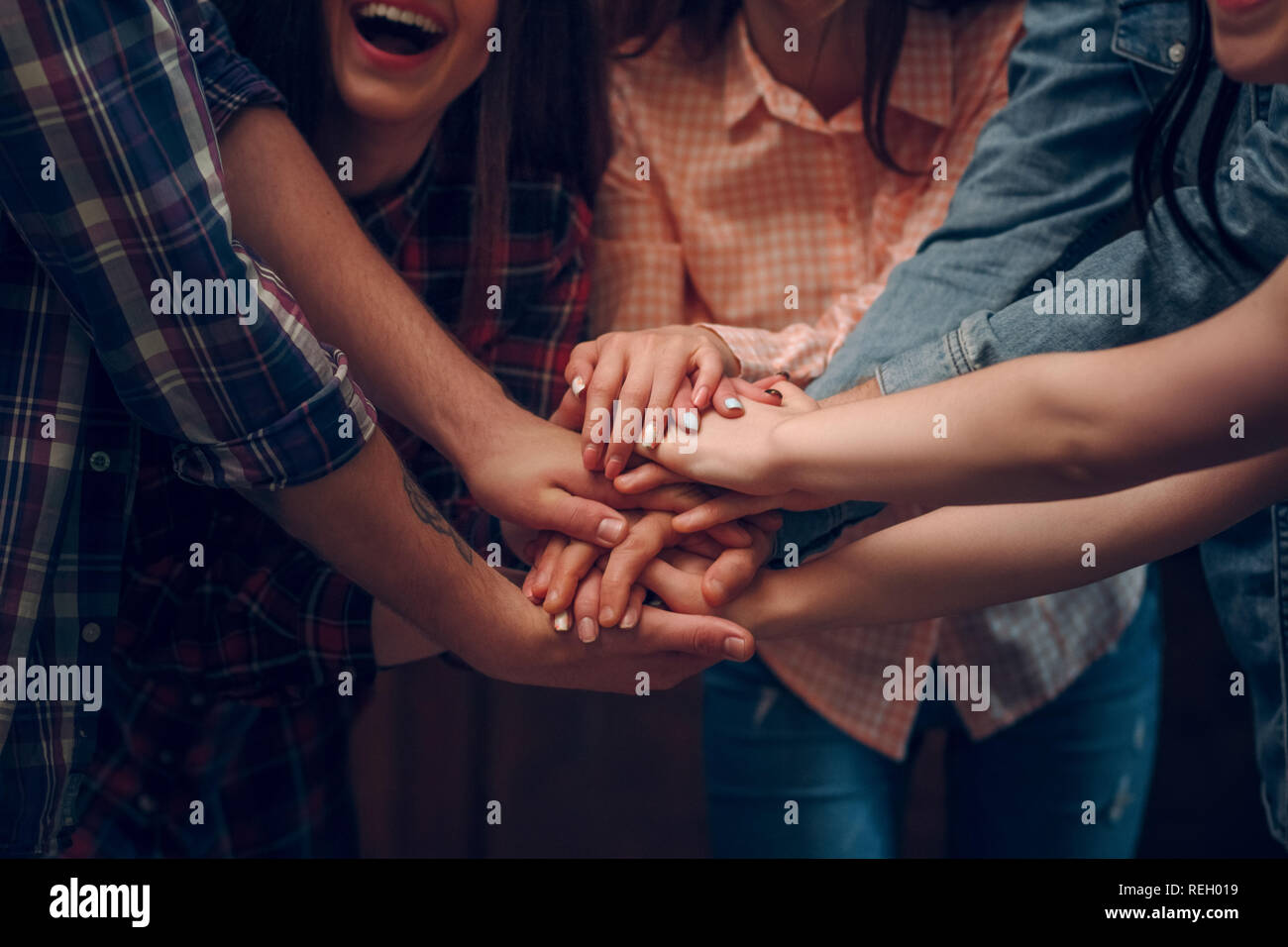Close up top view of people putting their hands together Stock Photo ...
