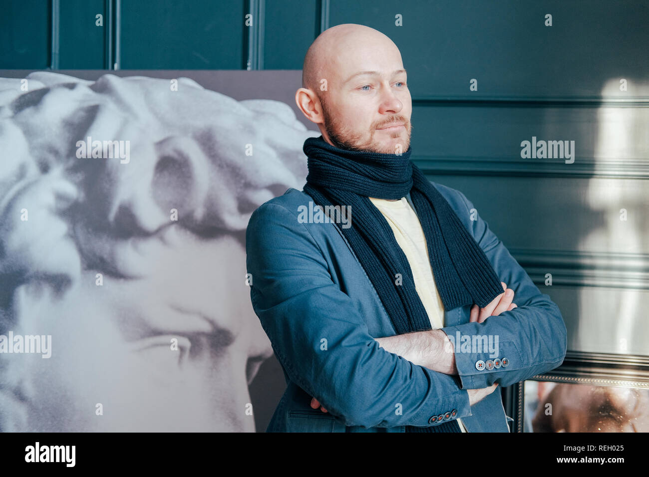 Portrait of attractive adult successful bald man art critic historian ...