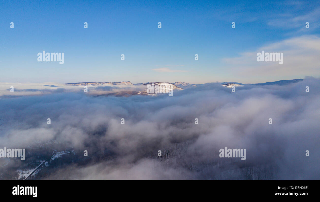 Aerial landscape - Lago-Naki, clouds under mountains Stock Photo - Alamy