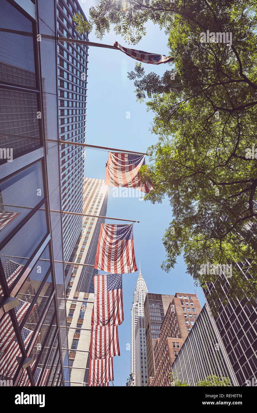 Looking up at American Flags in downtown New York with lens flare ...