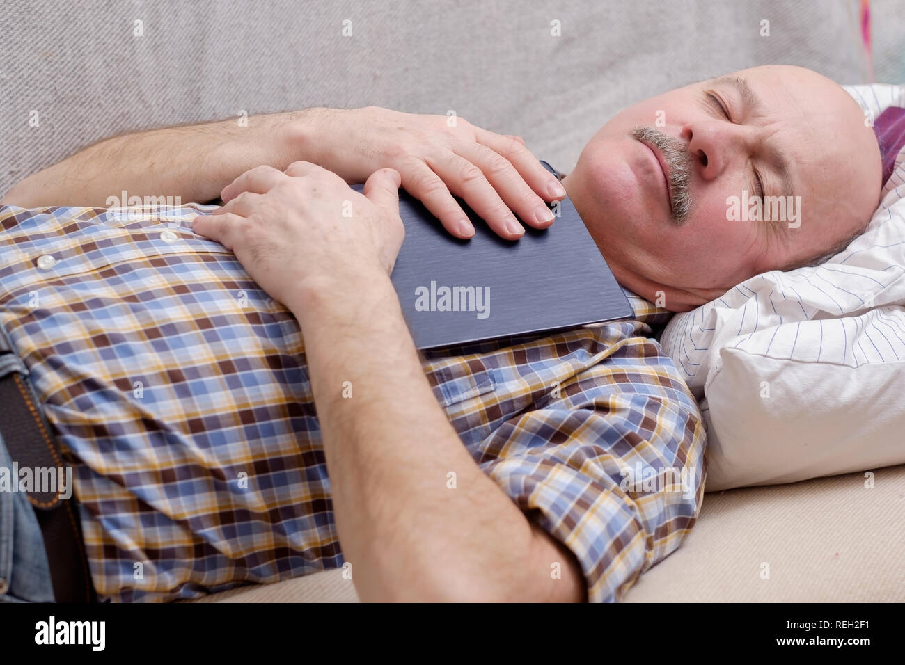 Old man sleeping on sofa hi-res stock photography and images - Alamy