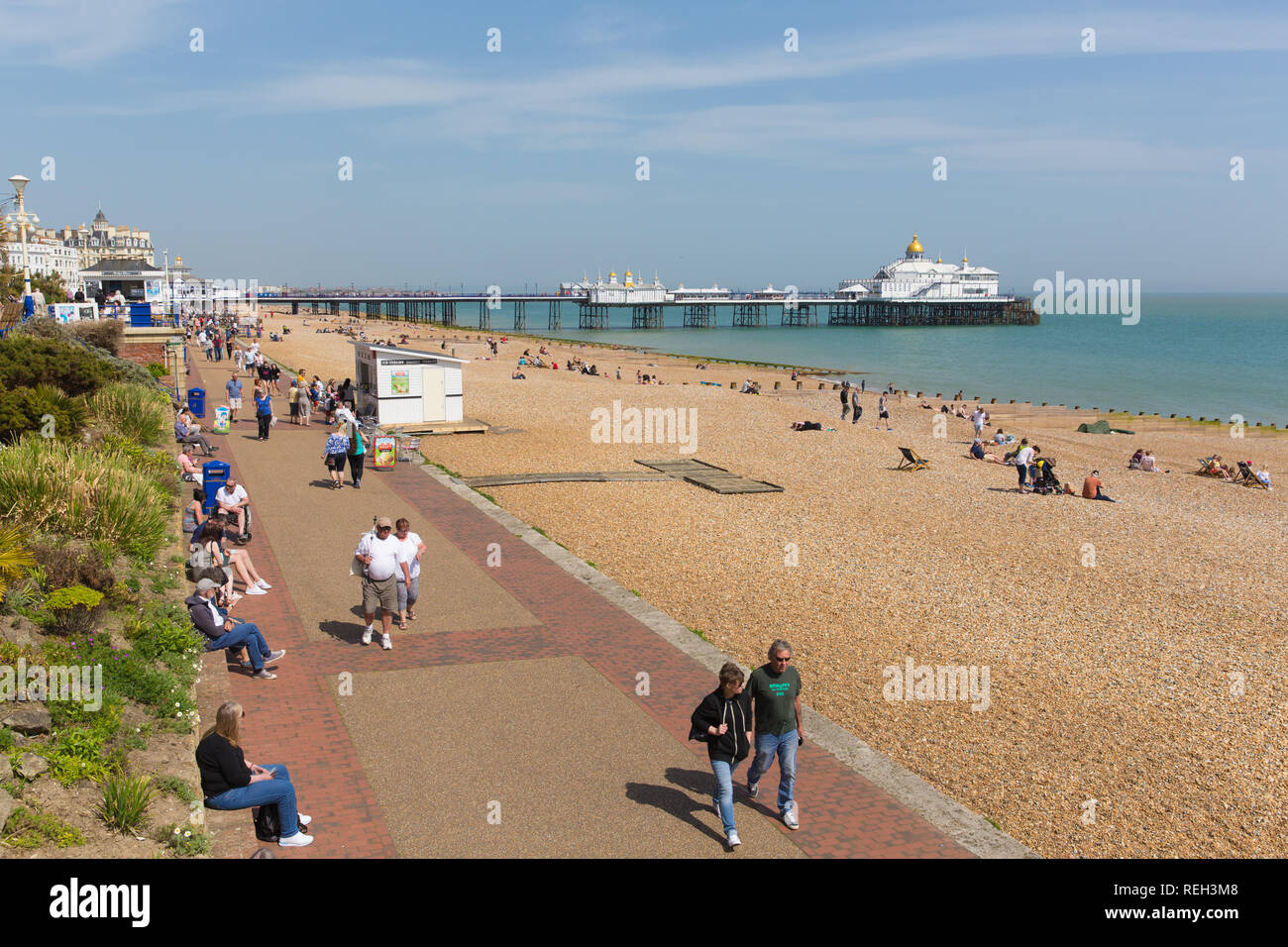 Eastbourne promenade beach and pier in fine weather with holidaymakers ...