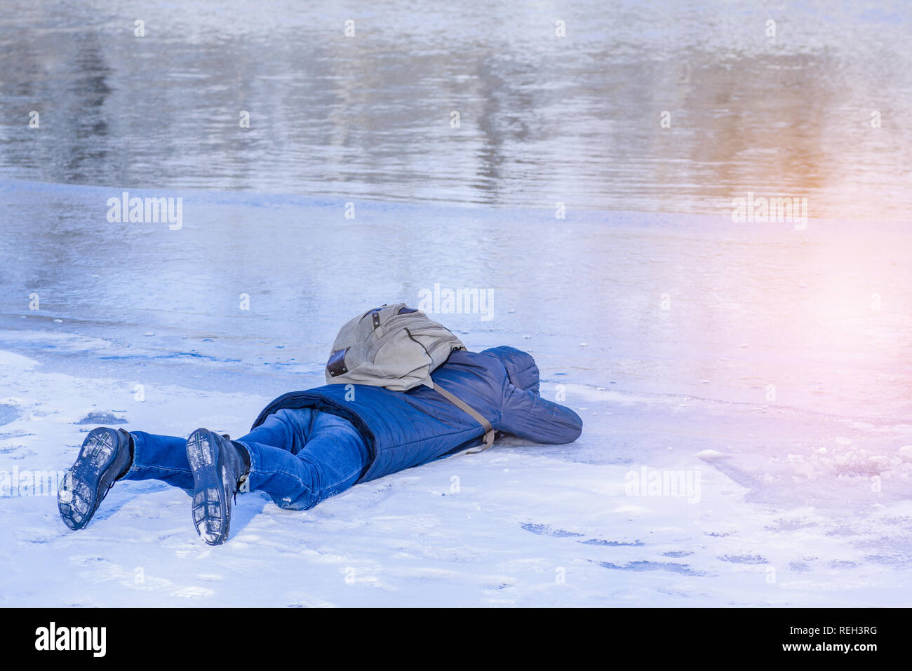 The man lies on ice in the winter,a man lies on the ice of the winter ...