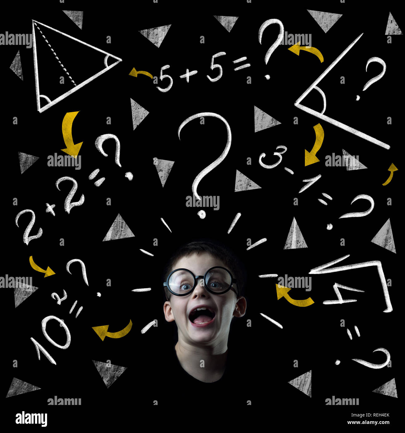 boy solve mathematics examples at the blackboard on black background ...