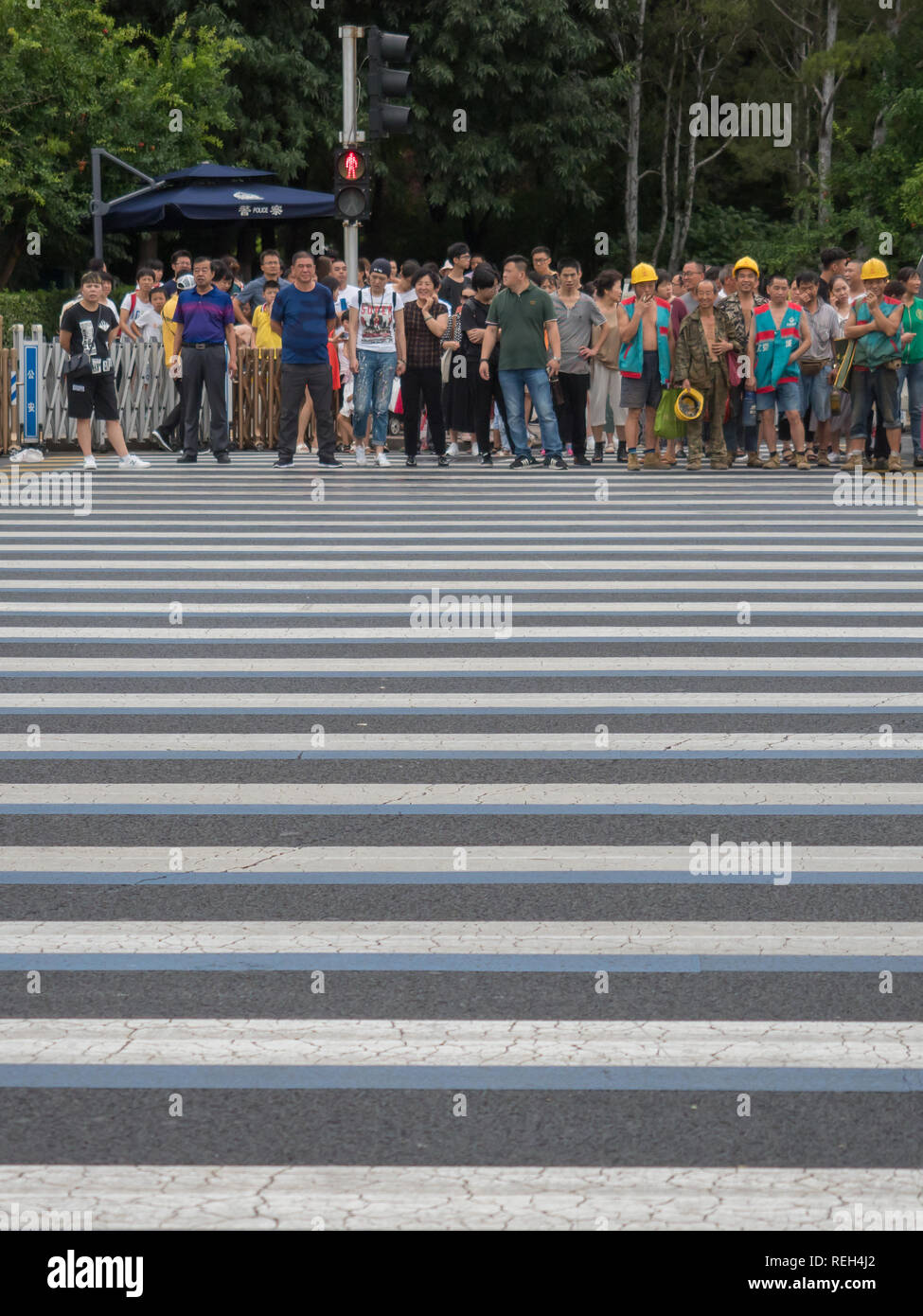 Beijing, China, August 2018, pedestrian crossing and people passing ...