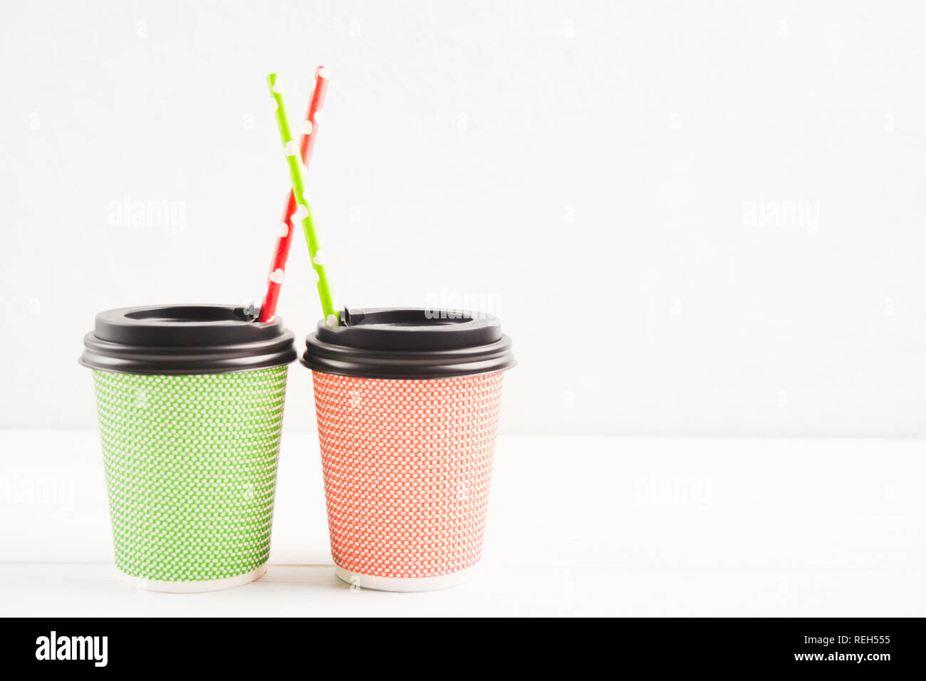 Green and red paper cups with plastic cover and paper straw Stock Photo ...