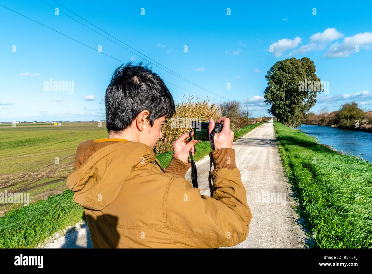 young man taking picture on natural background Stock Photo - Alamy