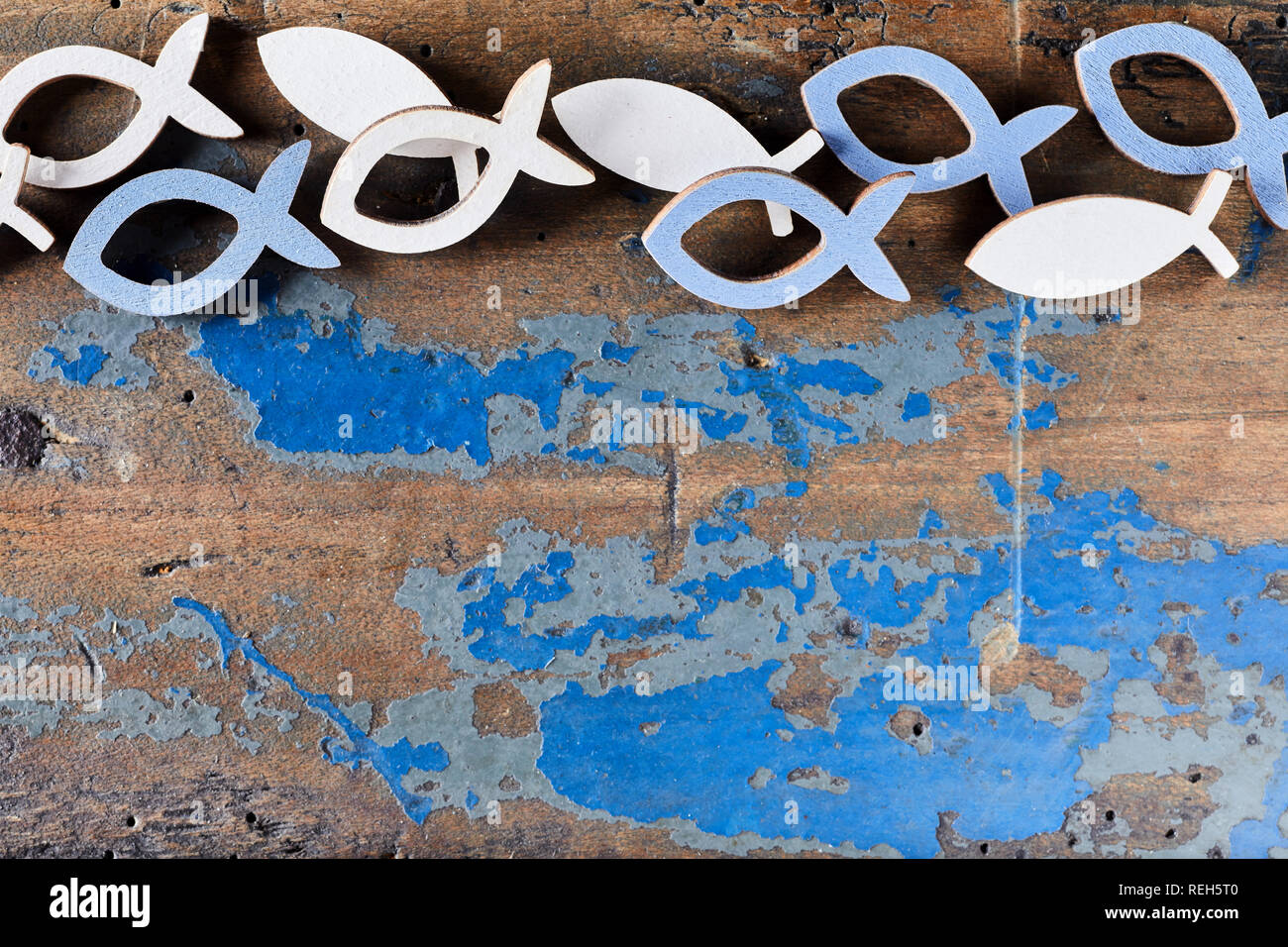 Creative Catholic background with fish shapes on an old wooden surface ...