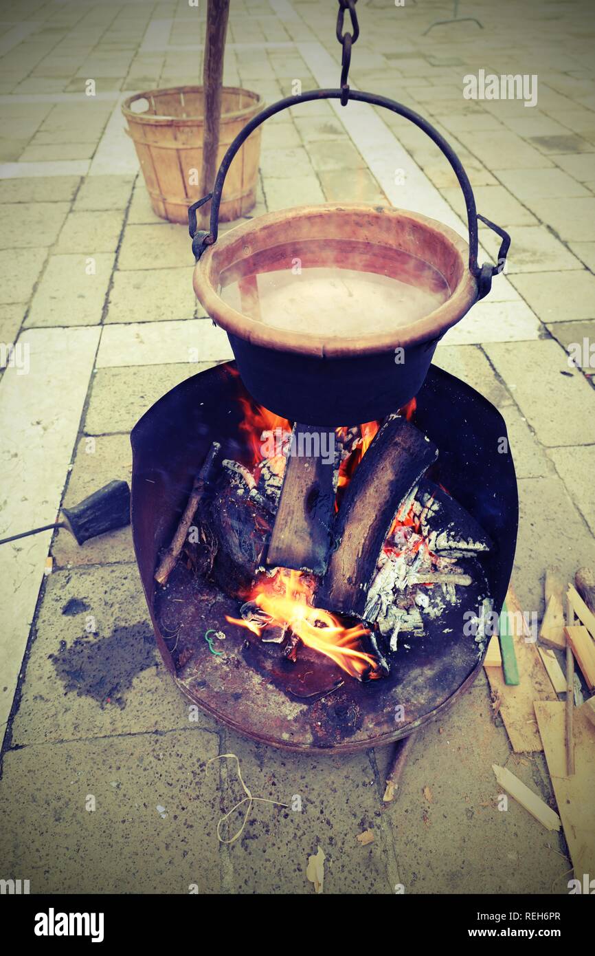 old copper cauldron with fire made from logs and antique effect Stock ...