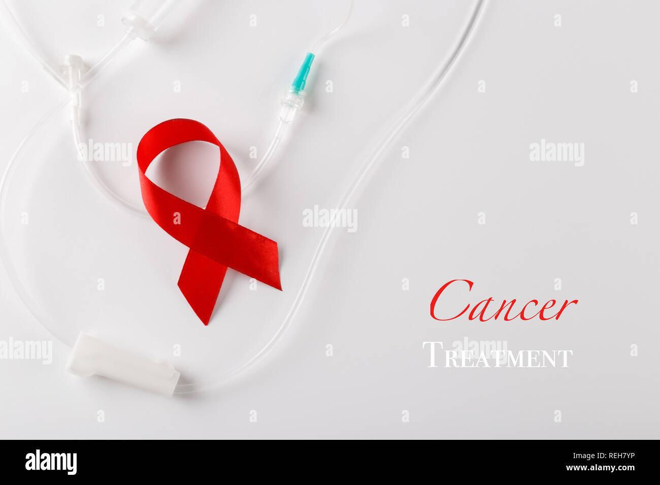 Cancer treatment text on withe background with red ribbon and ...