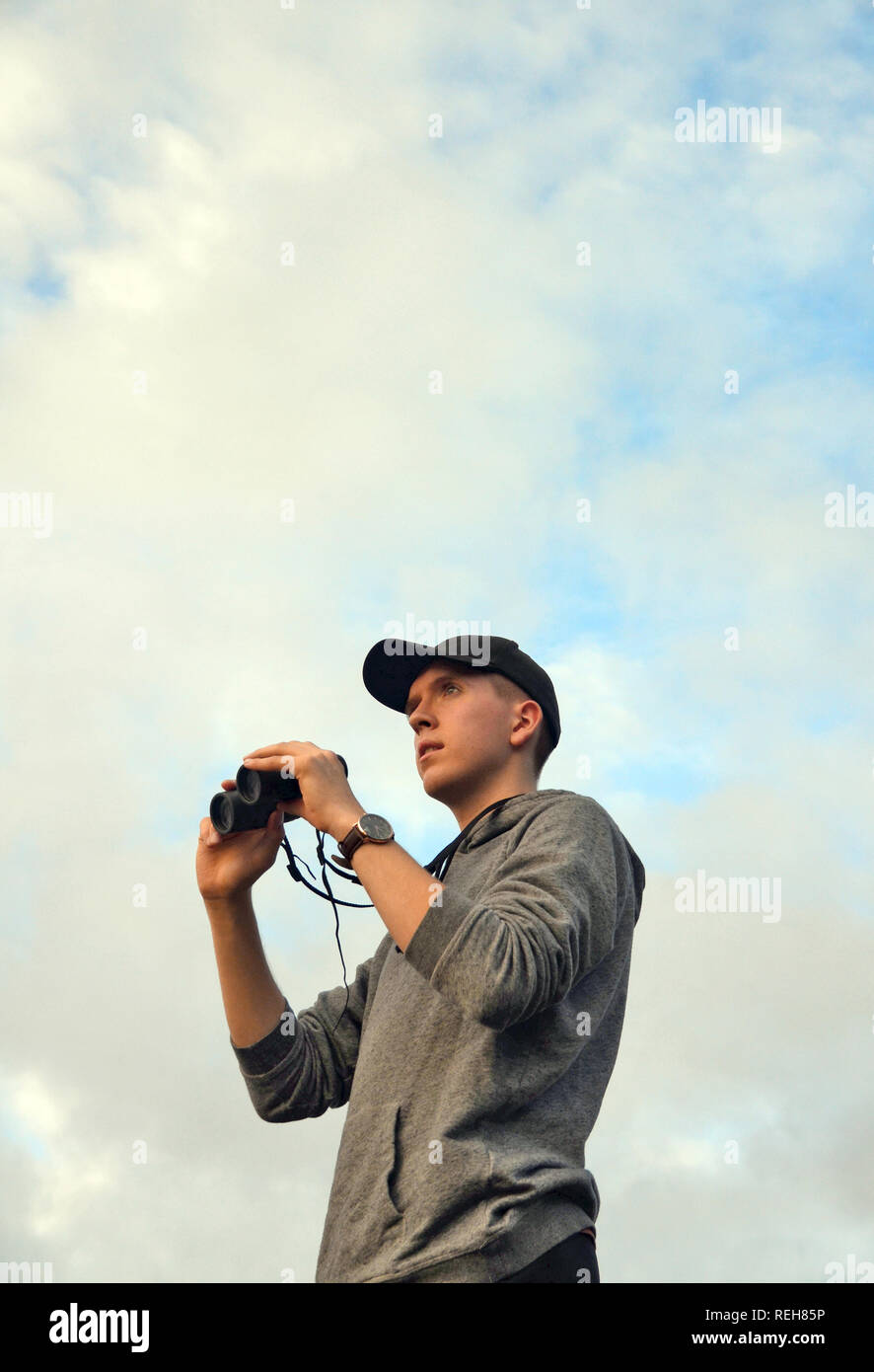 Teenage boy / young man holding binoculars Stock Photo - Alamy