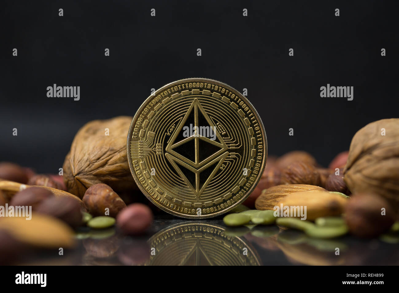 Ethereum Classic cryptocurrency physical coin surrounded with variety ...