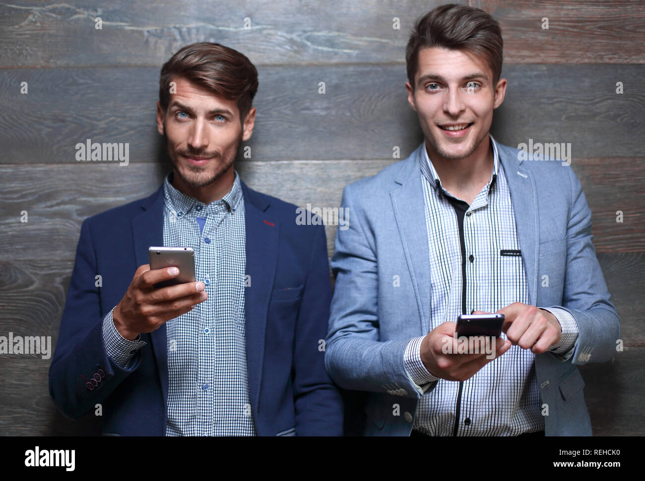 young guys with phones in their hands Stock Photo - Alamy