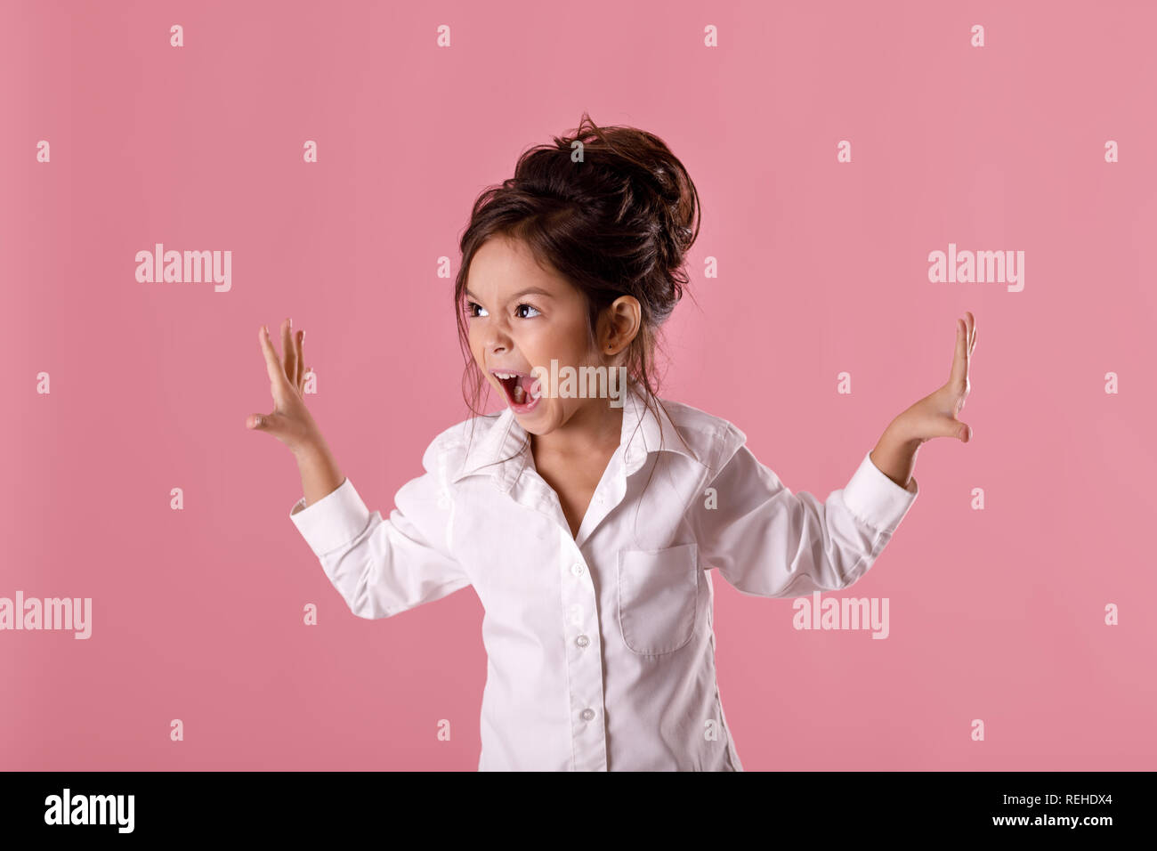 angry little child girl in white shirt with hairstyle Stock Photo - Alamy