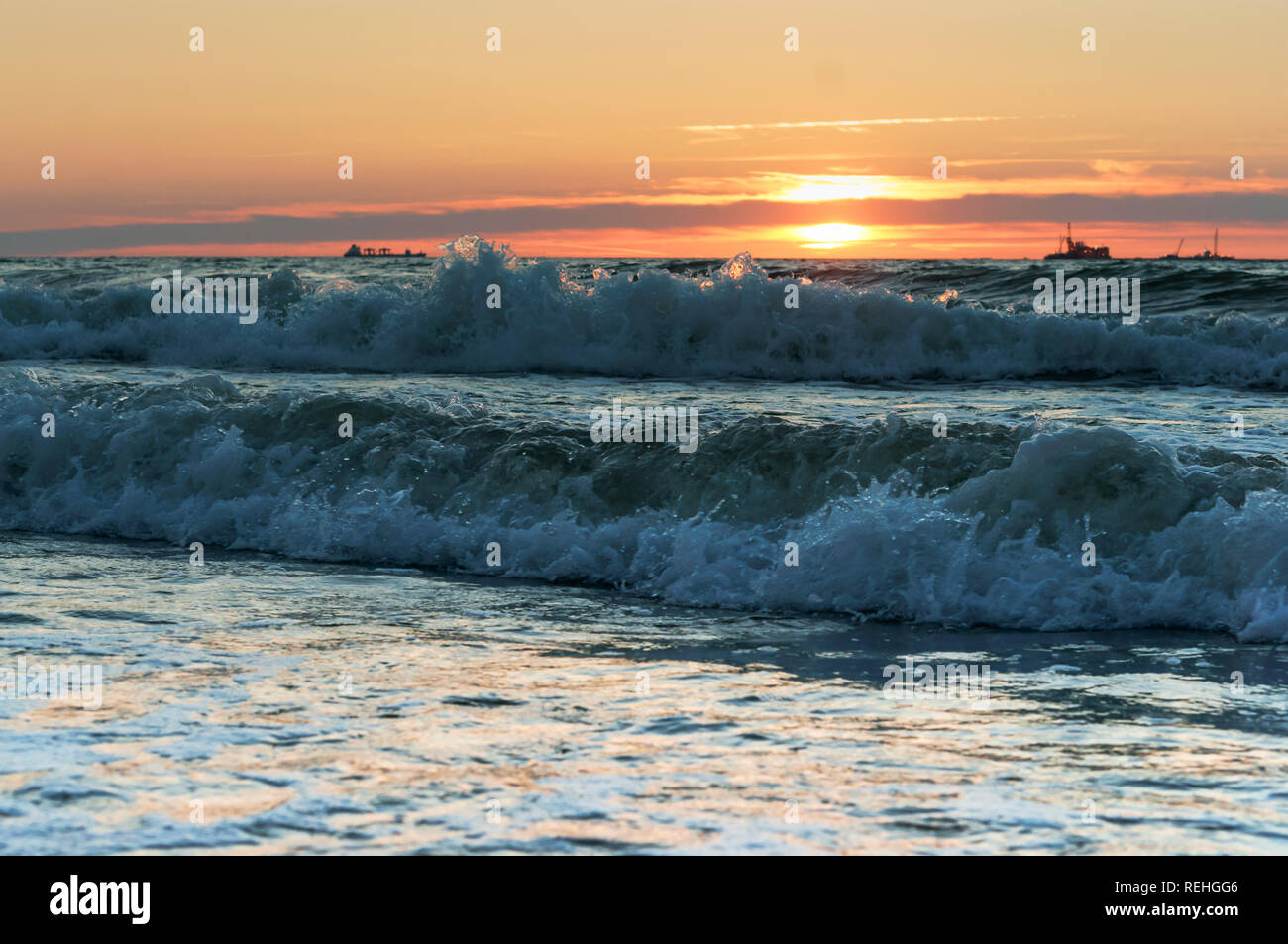 Sunset over the sea. Reflection of sunlight in the sea waves. Red sky ...