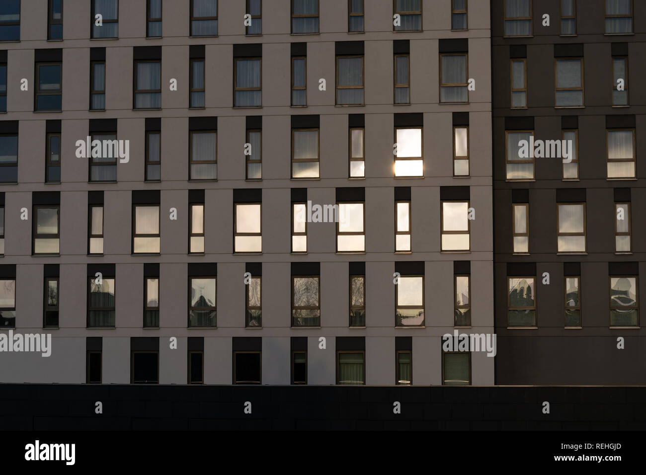 Reflection of sun in windows of building Stock Photo - Alamy
