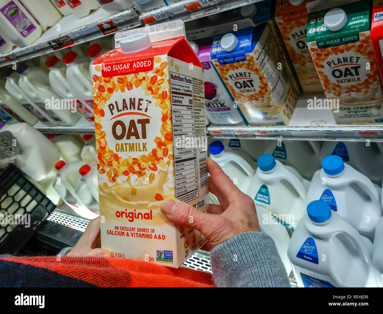 A discerning consumer chooses a half-gallon container of Planet Oat ...
