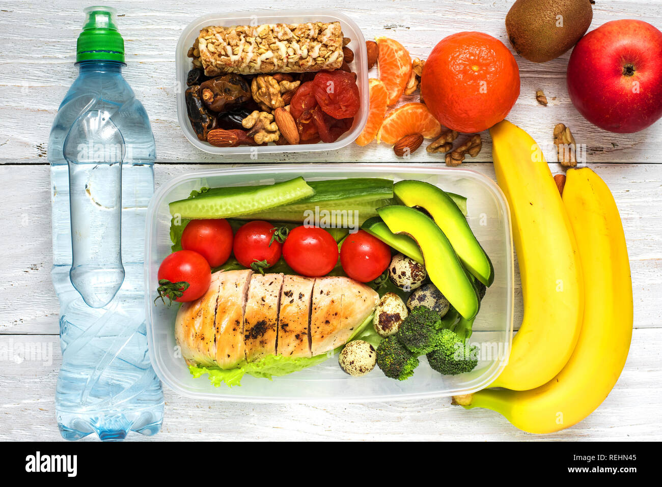 Healthy lunch boxes with chicken, fresh vegetables, fruits and nuts ...