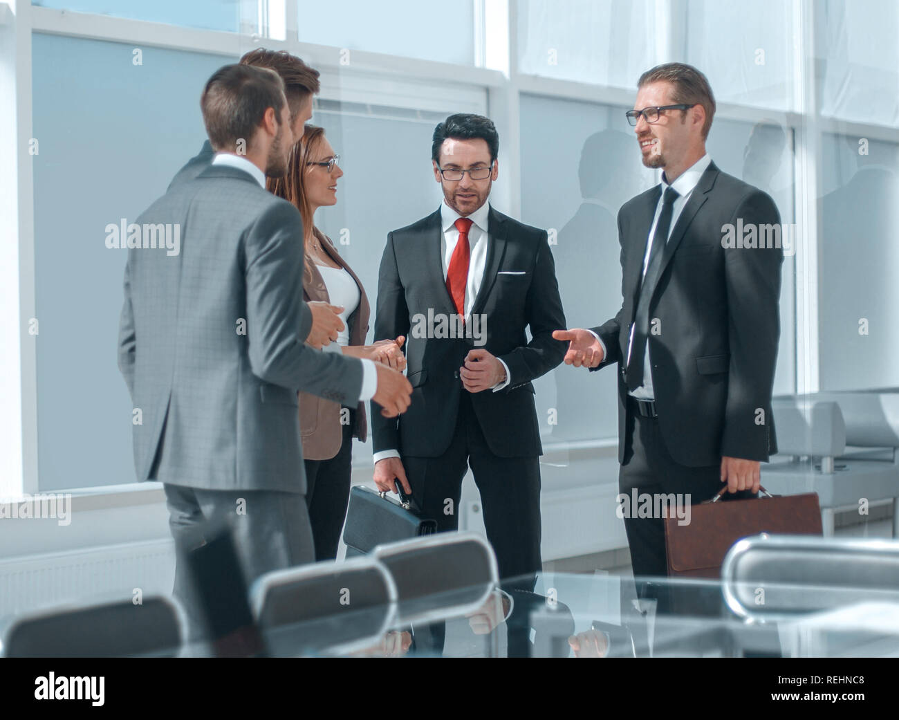 employees talking standing in the office Stock Photo - Alamy