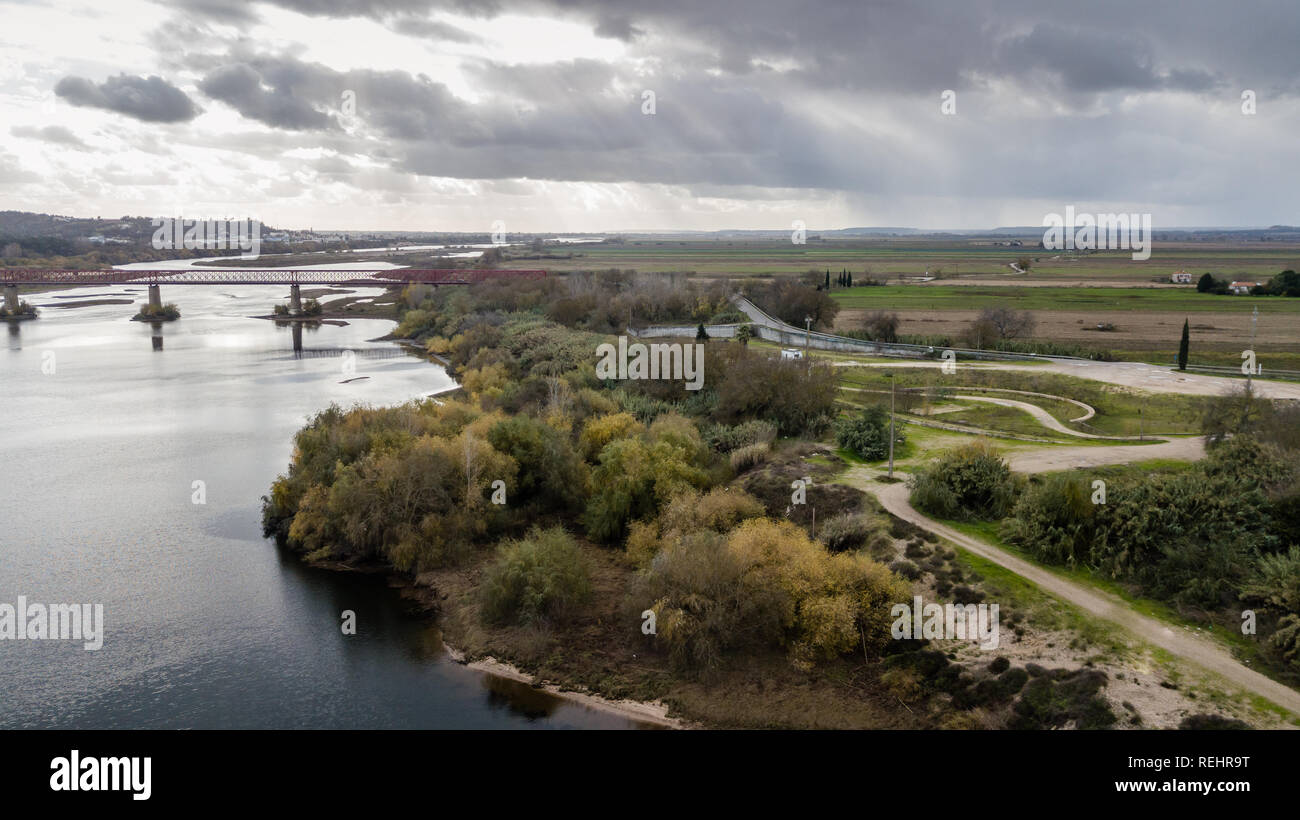 Landscape of Chamusca Bridge with a tagus river and a cloudy sky ...