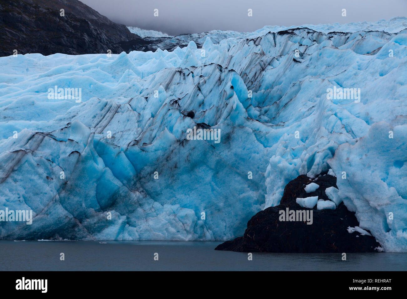 Pinnacles of blue ice march towards the water. Portage Glacier, Alaska ...
