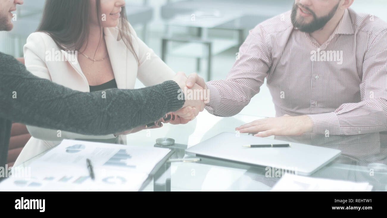 close up.handshake of commercial partners at the negotiating table ...