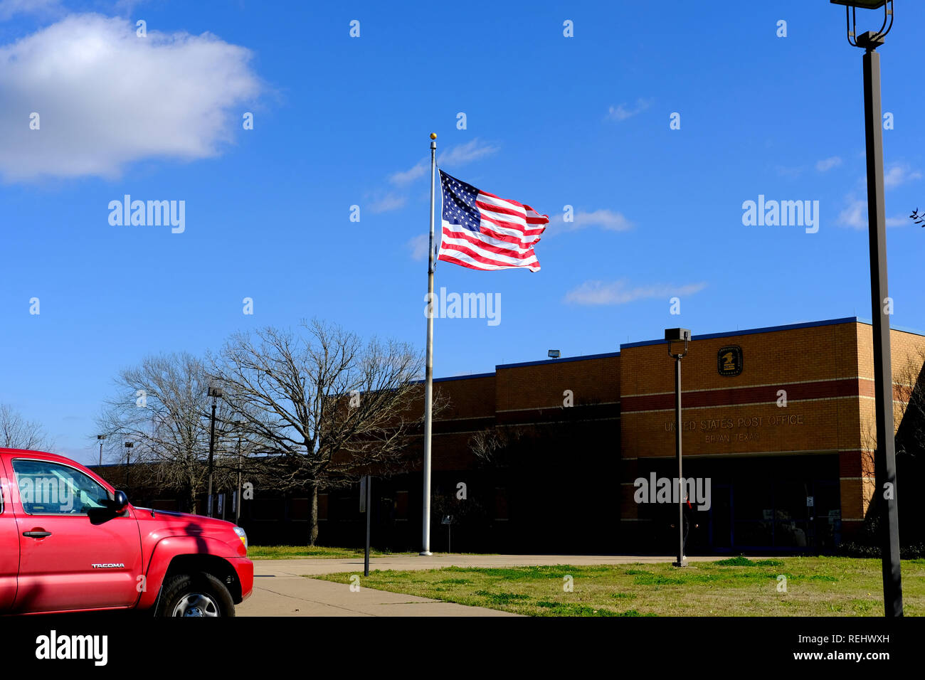 American flag outside the Bryan, Texas, USA post office; flag waving in ...