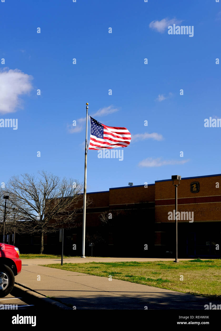 American flag outside the Bryan, Texas, USA post office; flag waving in ...