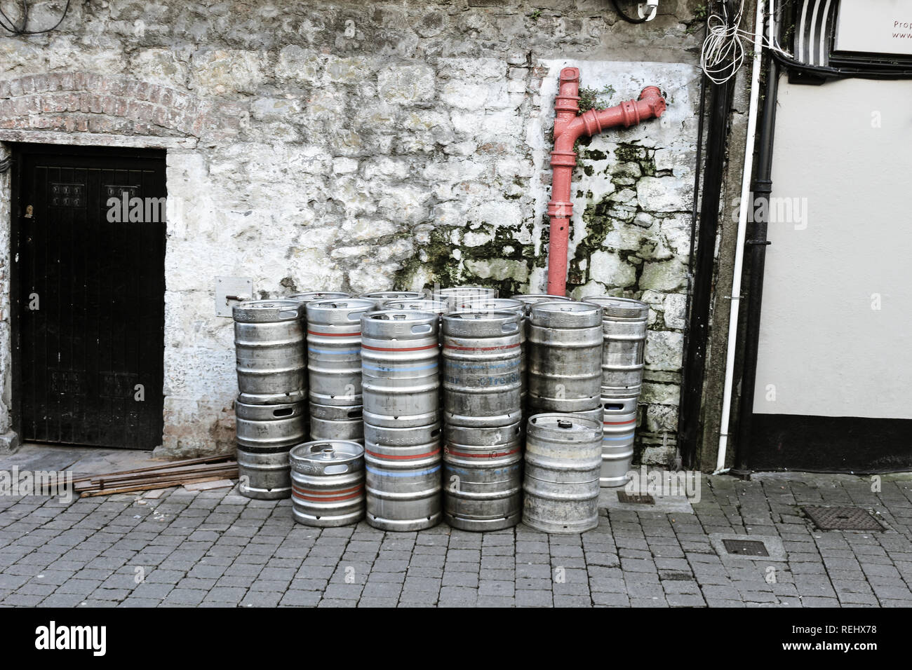 Multiple empty metal kegs outside a bar Stock Photo - Alamy