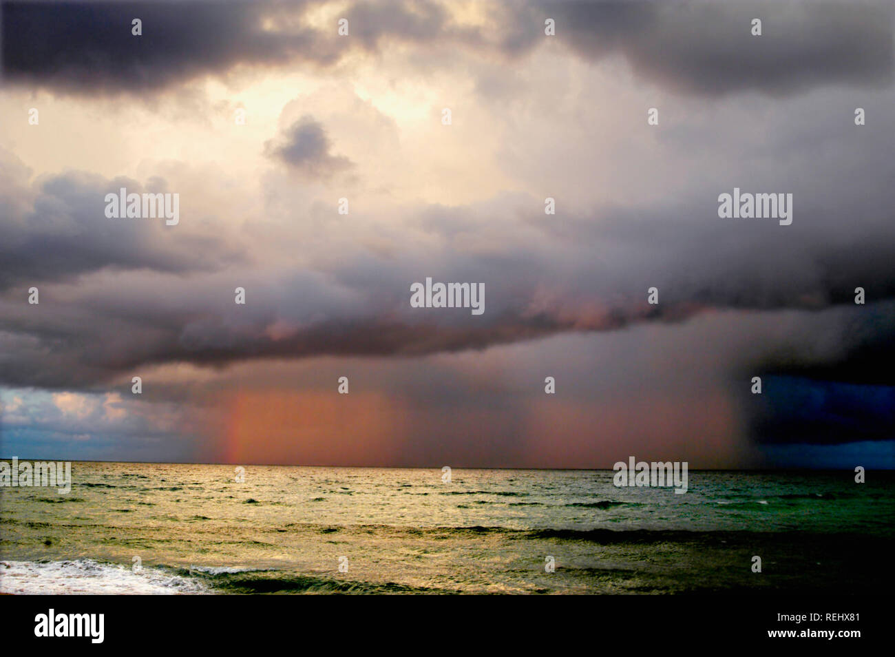 Thunderstorm Over the Atlantic Ocean at Sunset creating a Prism Stock ...
