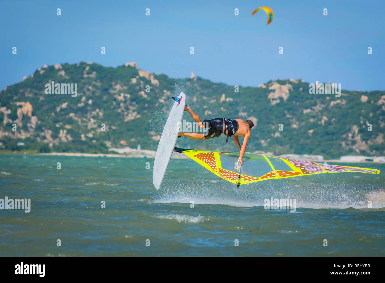windsurfer athlete performing extreme windsurfing tricks and jumps in ...