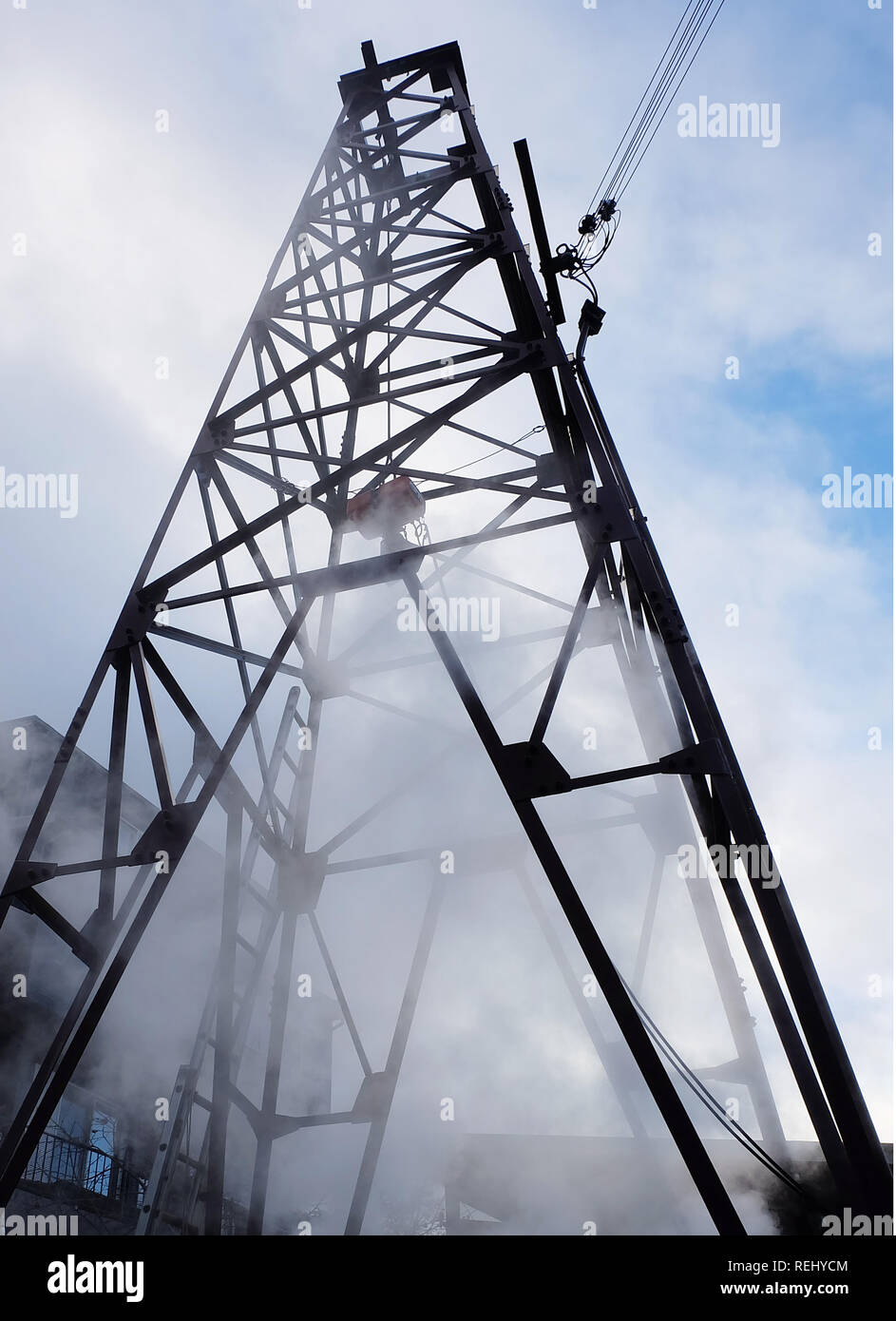 A metal steel tower structure with electrical cables attached to it ...