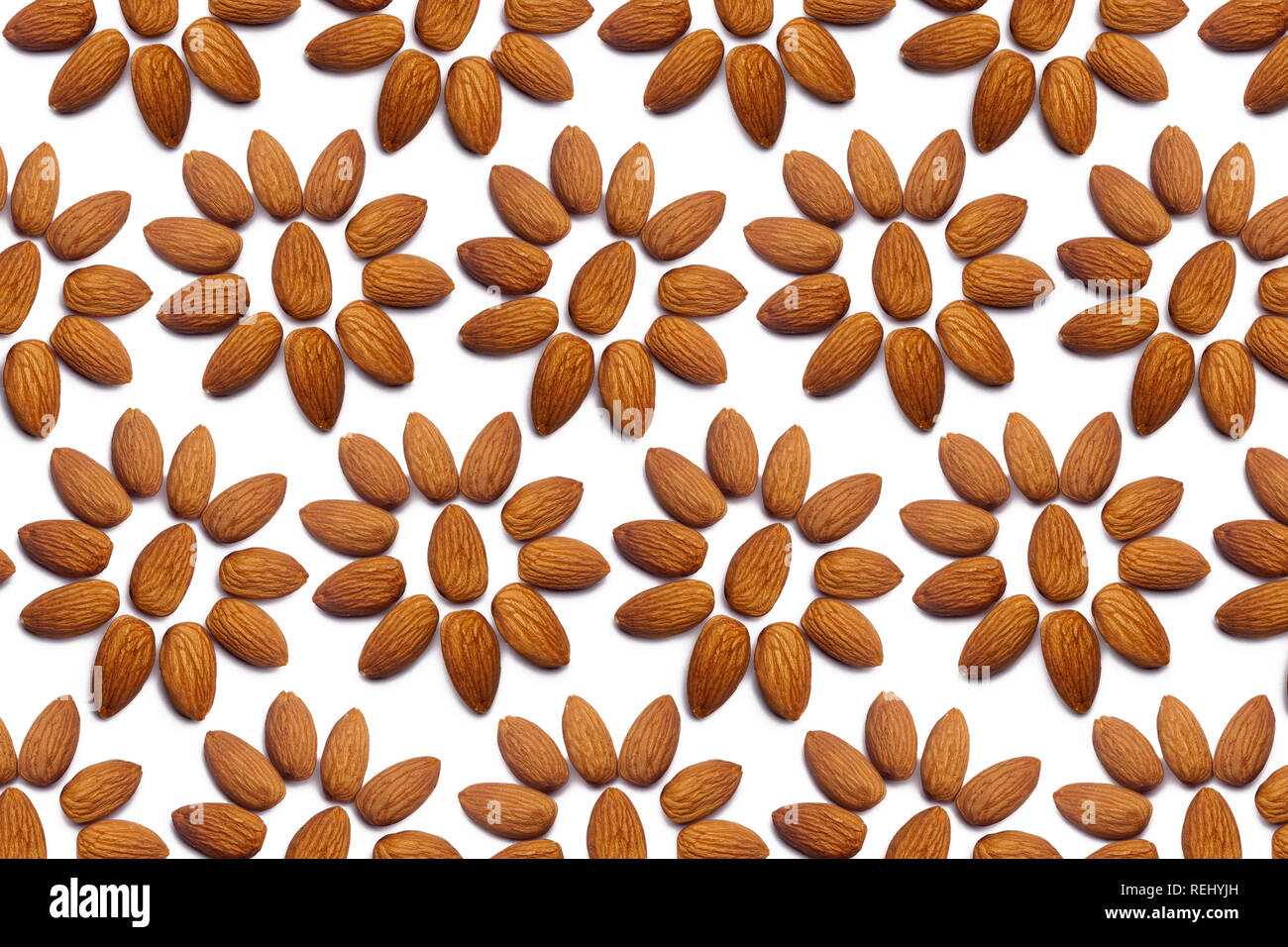 A collection of peeled almond nuts lies in the shape of a circle or sun ...