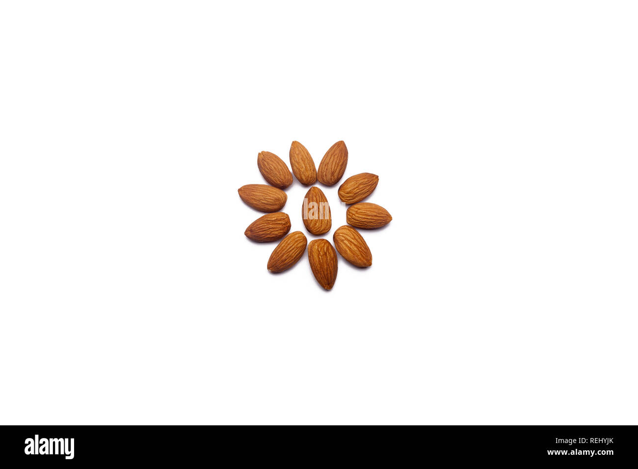 A collection of peeled almond nuts lies in the shape of a circle or sun ...