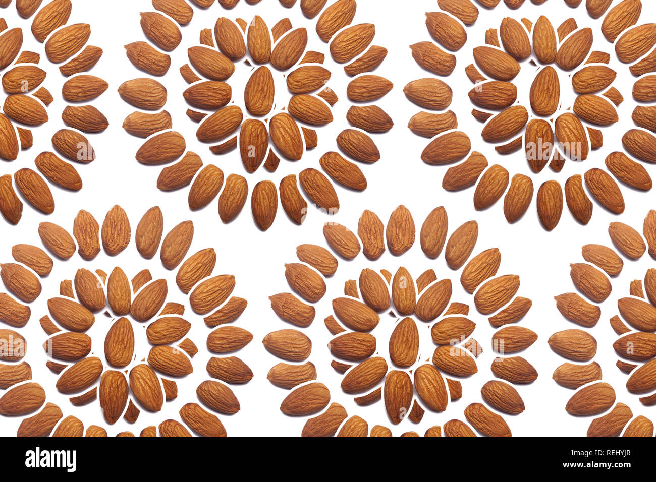 A collection of peeled almond nuts lies in the shape of a circle or sun ...