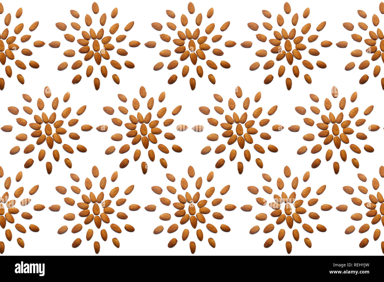 A collection of peeled almond nuts lies in the shape of a circle or sun ...