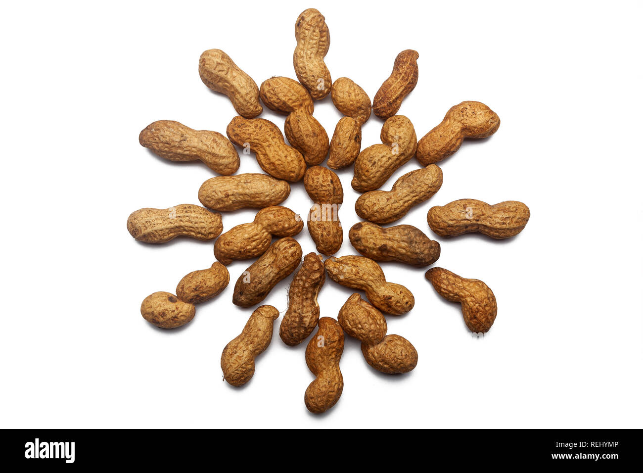 A collection of unrefined peanut nuts lie in the shape of a circle or ...