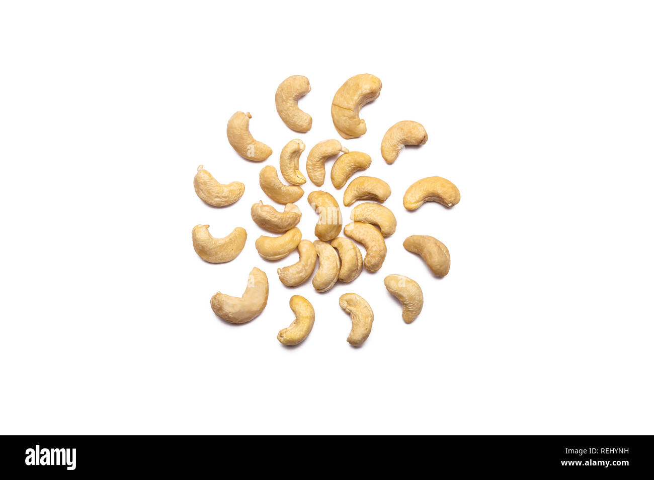 A collection of cashew nuts lie in the shape of a circle or sun on an ...