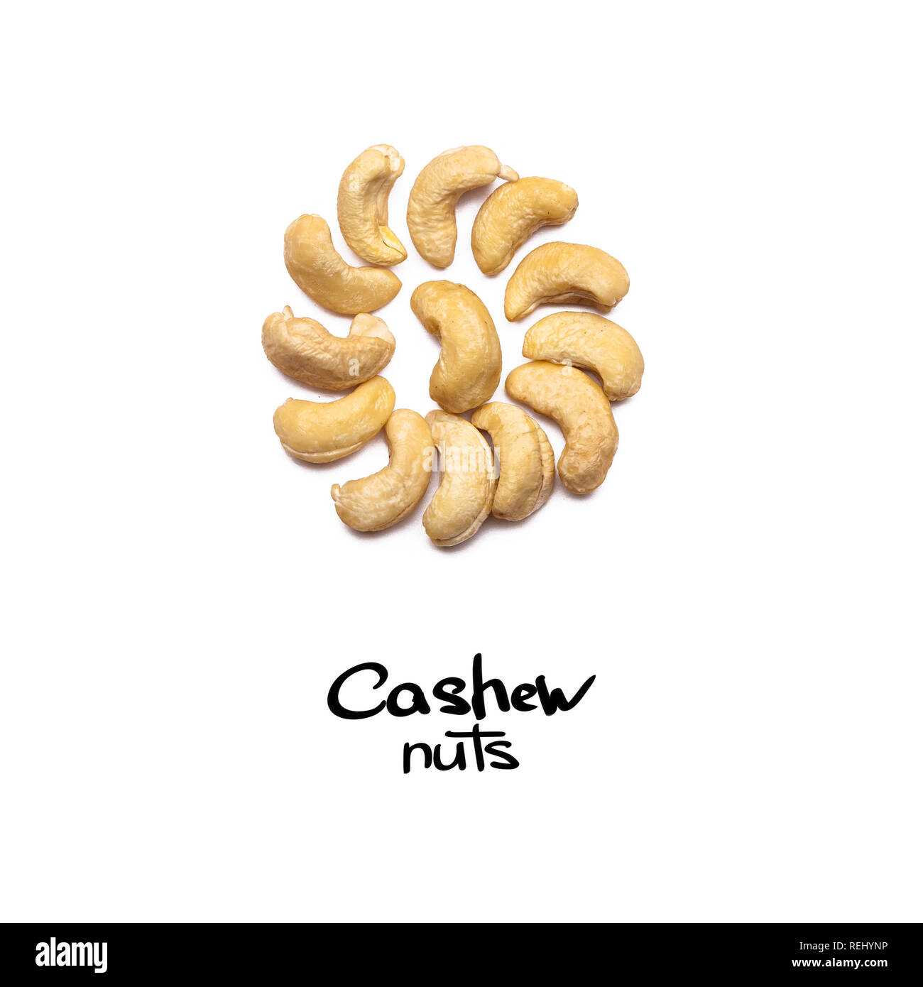 A collection of cashew nuts lie in the shape of a circle or sun on an ...