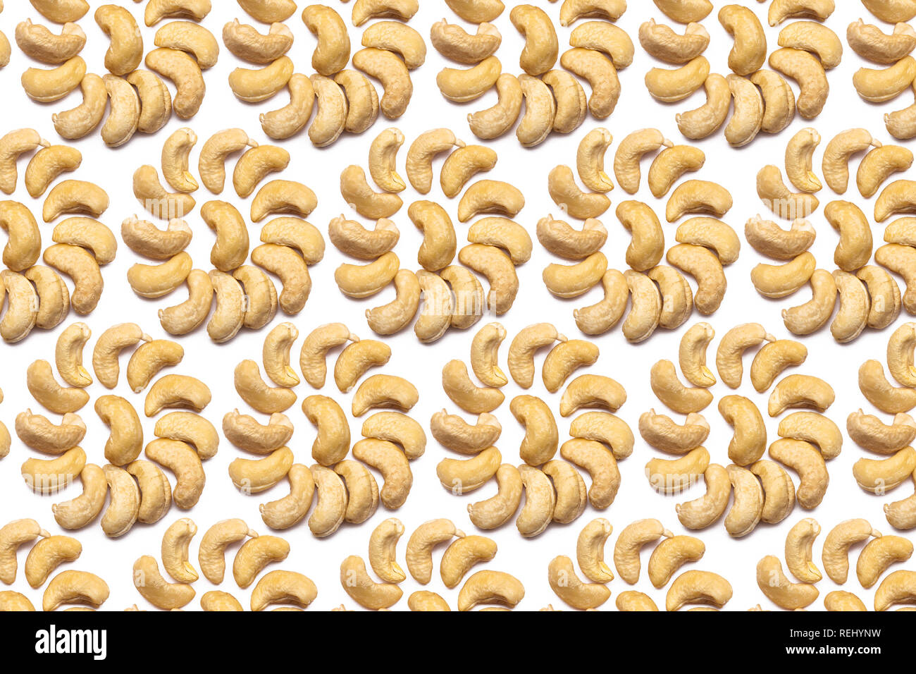 A collection of cashew nuts lie in the shape of a circle or sun on an ...