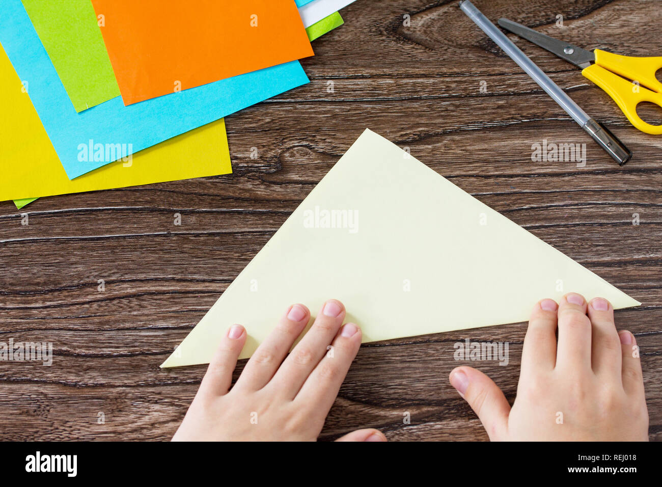 The child folds the parts Origami toy made from paper puppets cat ...